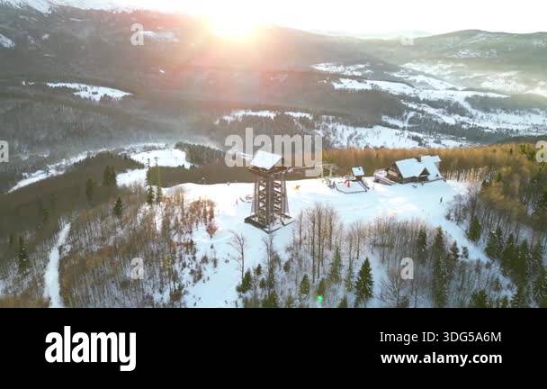 Scenic winter landscape featuring a distant observation tower amidst ...
