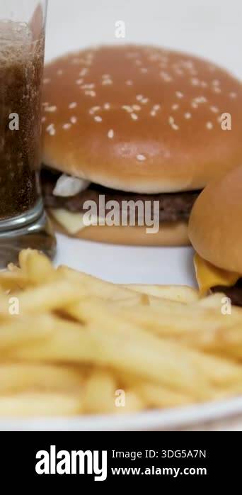 Fresh tasty burger served with soda and french fries on white table ...
