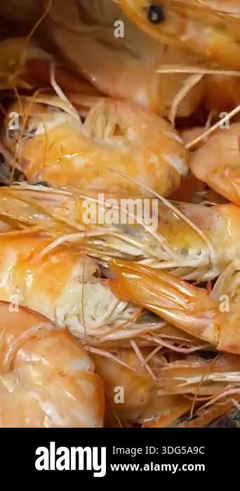 Peeling boiled shrimp on a wooden cutting board at home. High quality ...