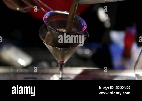 Vertical video. Pouring alcohol cocktail. Bright drink. Bartender hand ...