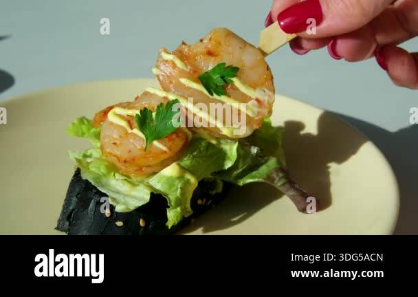 Skewered shrimp served with sweet potato fries, mixed greens, cucumbers ...