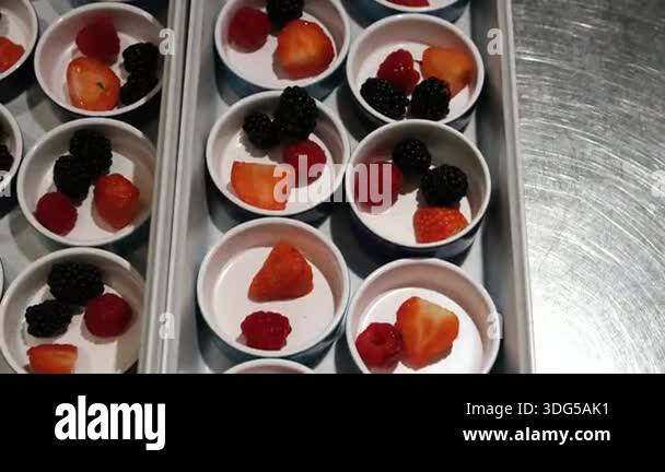 Greek yogurt with raspberry and blueberry scooped with spoon from a ...