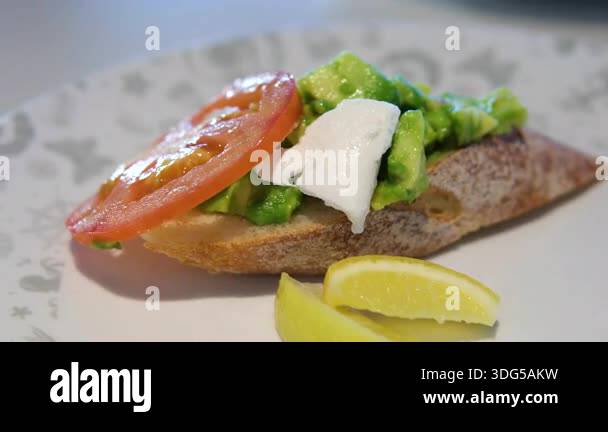 Avocado Toast In Hand. Person holding piece of bread with guacamole and ...