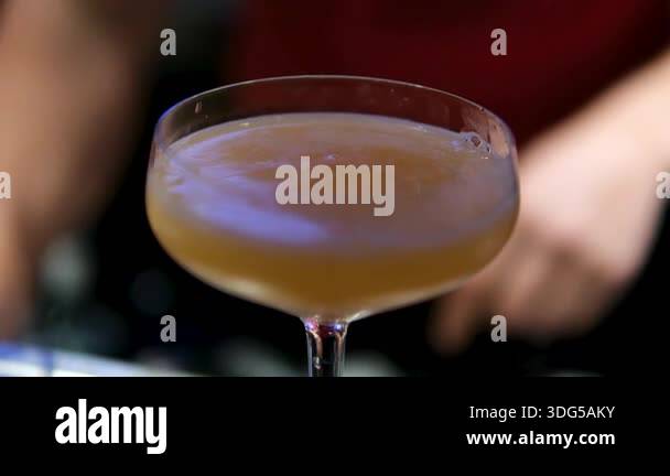 close-up view cocktail in restaurant. barman behind counter makes ...