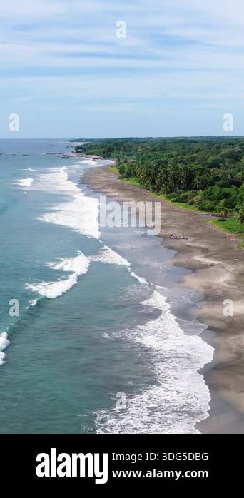 Stunning aerial perspective of ocean waves washing ashore on a ...