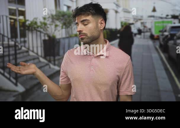 Man presenting open hand palm up on a city street in front of white ...