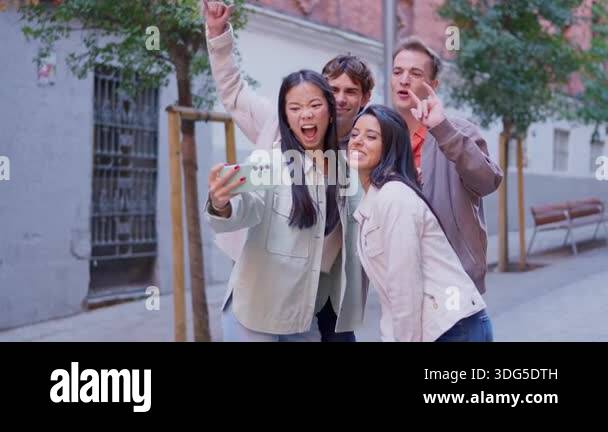 Happy multiethnic group of friends taking a selfie with a smartphone ...