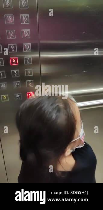 Malaysia, Bangi - January 22, 2023 Pressing the lift number, little ...