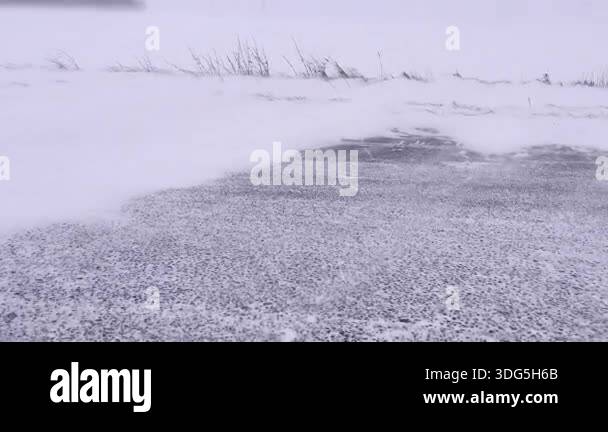 Country asphalt road at blizzard. Winter weather and rural landscape ...