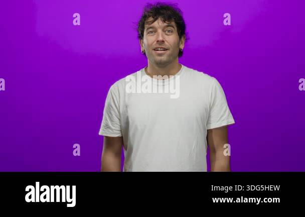 Hispanic man expressing joy with a wide smile and clasped hands against ...