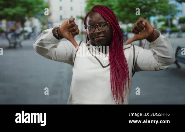 Woman expressing disapproval outdoors on a city street with trees and ...