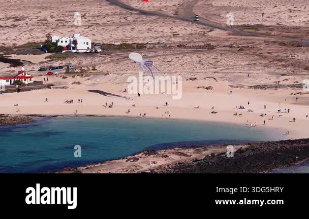 Aerial view of a crescent sandy bay in Fuerteventura shows turquoise ...