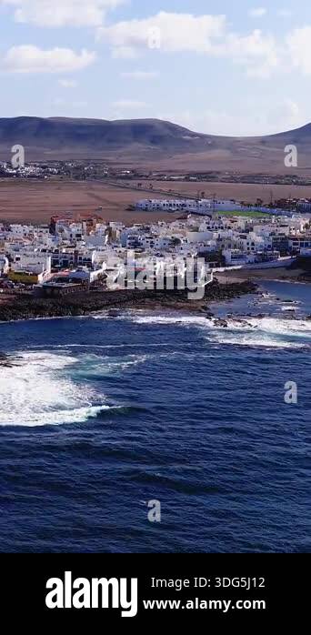 Aerial daytime view of a whitewashed coastal town on Fuerteventura as ...