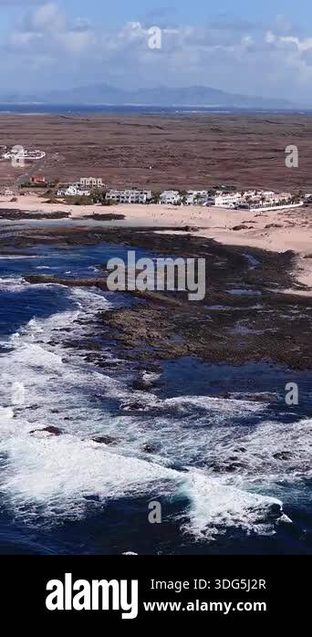 Aerial view of Fuerteventura coast, Atlantic waves on black lava, pale ...