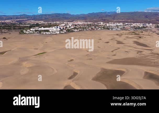 Aerial drone view of Maspalomas sand dunes, white resorts, Atlantic ...