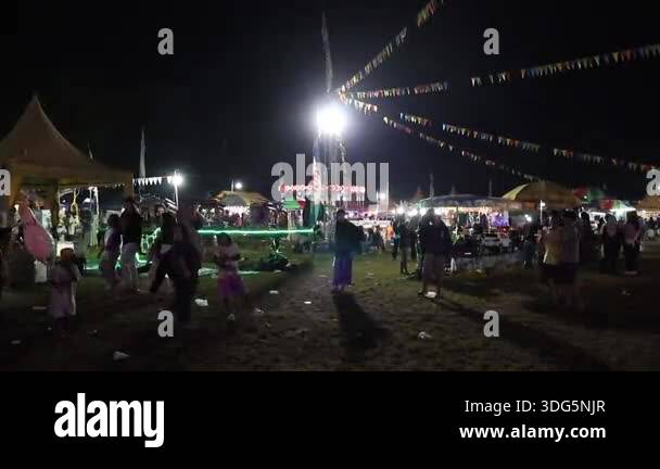 Visitors exploring the attractions at a local carnival in Mataram ...
