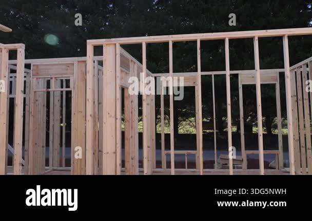 Workers are building wooden house frame, trusses roof supports studs ...