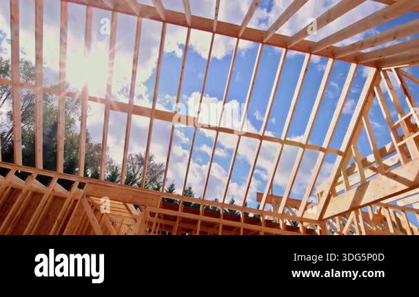 Wooden beams are being installed for roof structure under framing ...