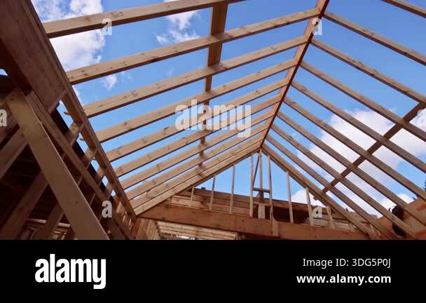 Workers construct building frame with wooden beams roof frame trusses ...