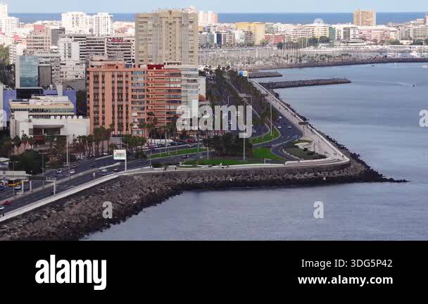 Aerial 4K view of Las Palmas de Gran Canaria waterfront shows curving ...
