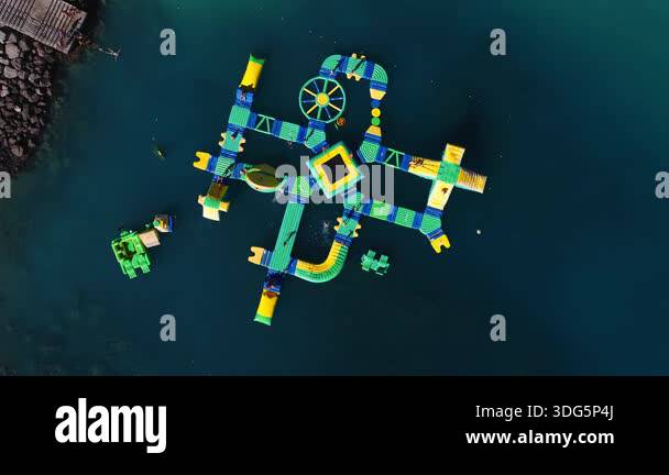 Aerial top down view shows a bright inflatable water park off Gran ...