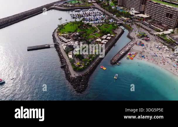 Aerial shot shows Anfi del Mar in Gran Canaria with marina, curving ...