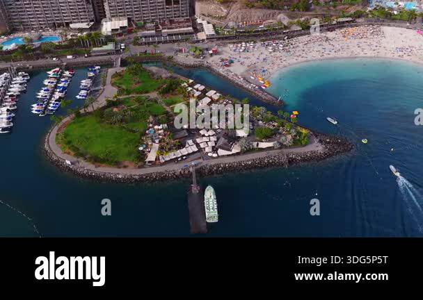Aerial view of Playa de Amadores, Gran Canaria, shows hotels, marina ...