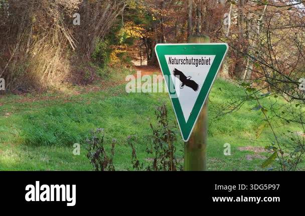 A sign with the German text Naturschutzgebiet stands at the entrance of ...