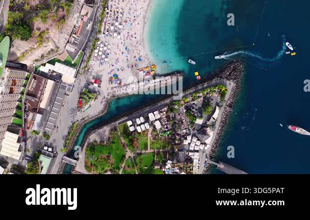 Aerial daytime view of Anfi del Mar, Gran Canaria. White sand, rock ...