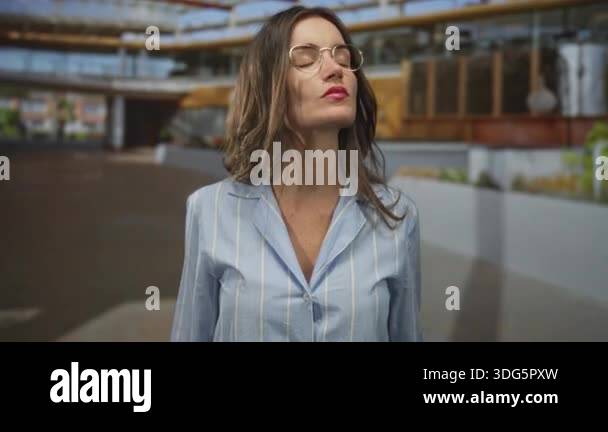 Woman with hands in a fighting gesture and intense stare outside a ...