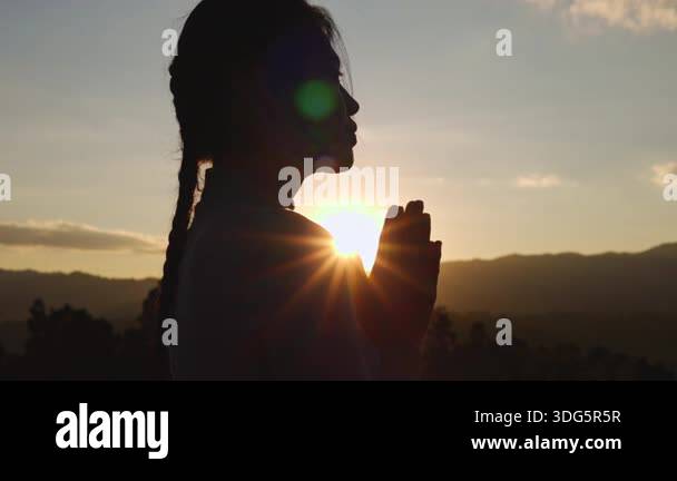 Video 4k Slow motion, Silhouette of woman Praying hands with faith in ...