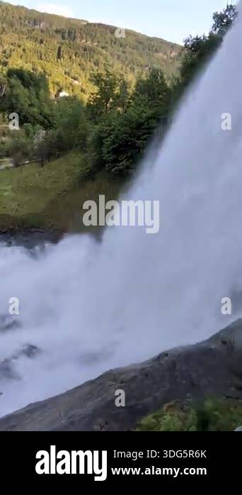 A massive white waterfall creates a powerful and misty display as it ...