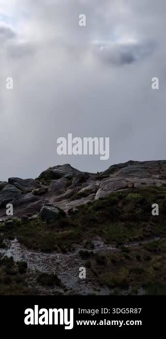 A mysterious mountain landscape features a winding stone path leading ...