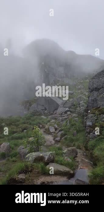 A mysterious mountain landscape features a winding stone path leading ...