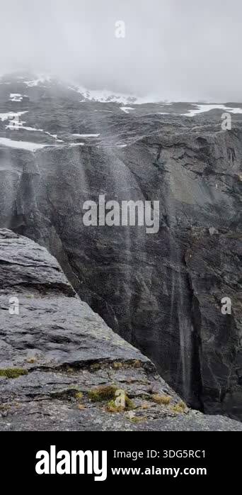 A high-altitude perspective captures several thin waterfalls cascading ...
