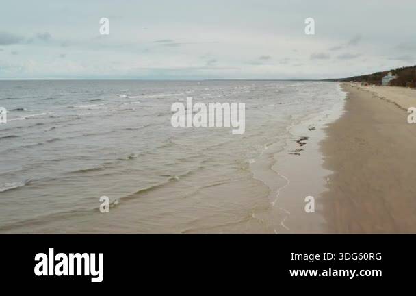 Sandy coastline and Baltic Sea waves in Jurmala Latvia from high angle ...