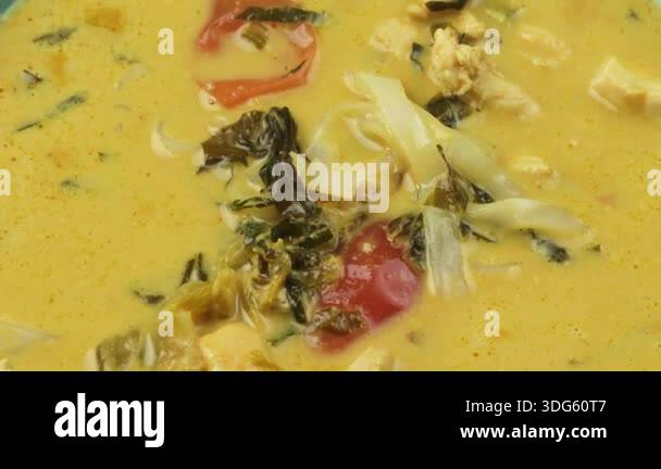 Chicken soup with coconut milk and curry Stock Video Footage - Alamy