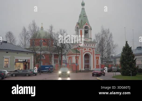 Traditional red Orthodox church and bell tower on a central square in ...