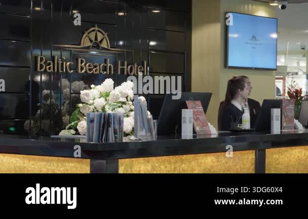 Professional female staff working at Baltic Beach Hotel reception ...