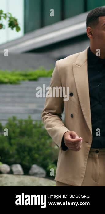 Stressed African American business man talking on mobile phone in city ...