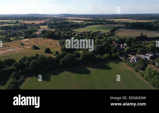 An aerial view captures a charming English countryside village nestled ...