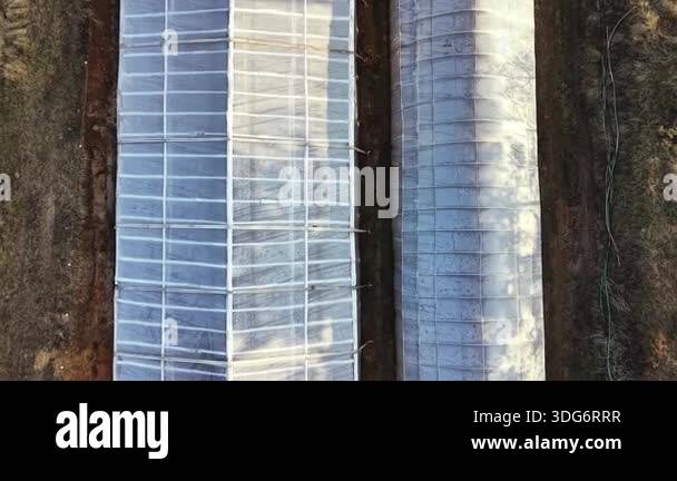 Row of greenhouses in a sunny rural field Stock Video Footage - Alamy