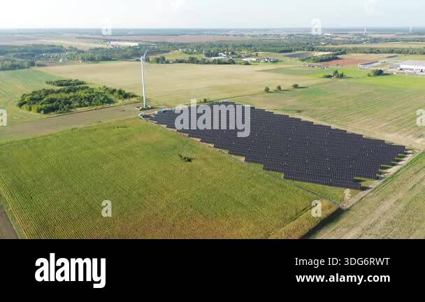 Modern solar power station and windmill in rural area Stock Video ...