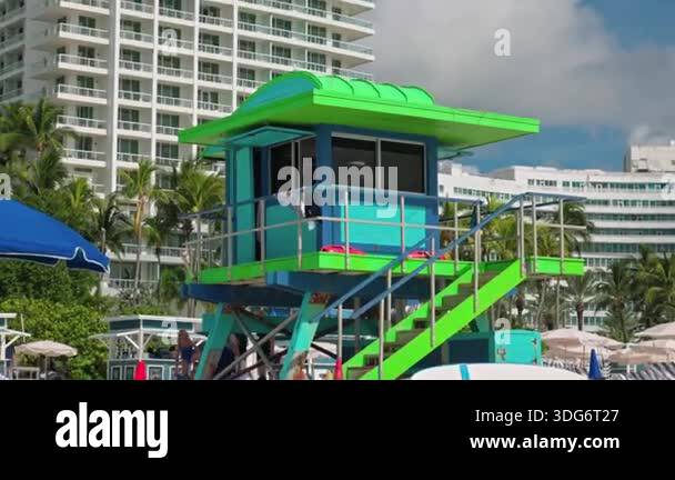 Beautiful view of lifeguard tower on sandy beach with palm trees and ...