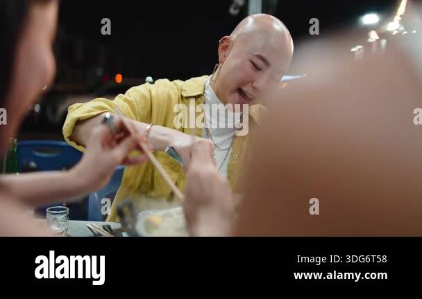 Group of happy young women cooking and eating a traditional thai ...