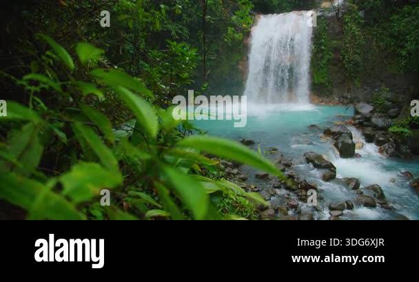 Blue Falls waterfall cascades into a vibrant turquoise pool surrounded ...