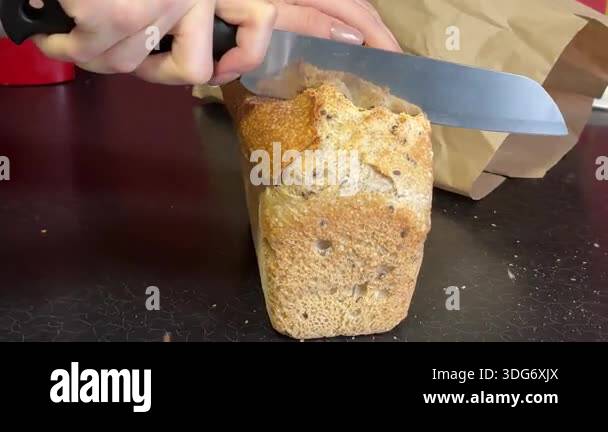Slices of whole wheat bread. Panning shot. chef slices fresh bread ...