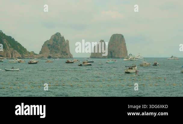 Small motorboats and yachts floating on the blue sea near massive ...