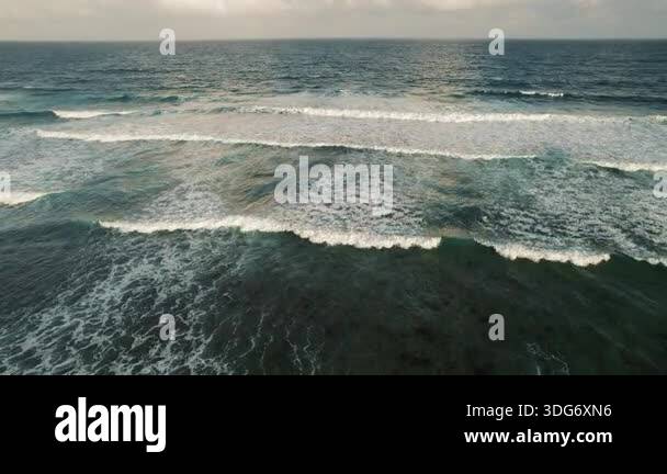 Ocean waves forming parallel lines approaching shallow reef in Yucatan ...