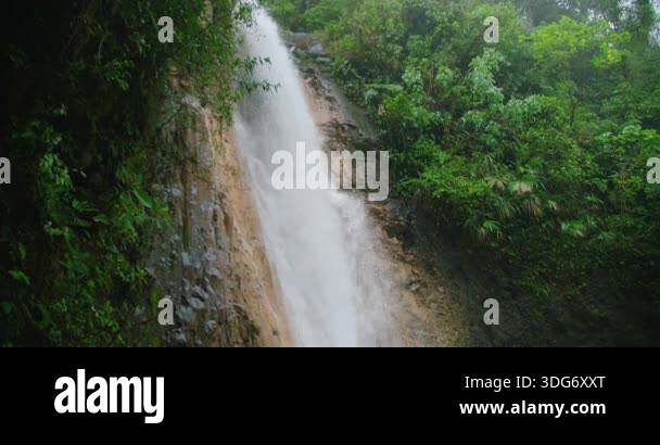Blue Falls waterfall plunges into a turquoise pool in lush Costa Rica ...